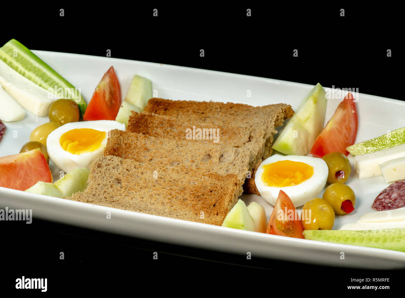 Delicious breakfast on white plate with isolated black background Stock ...