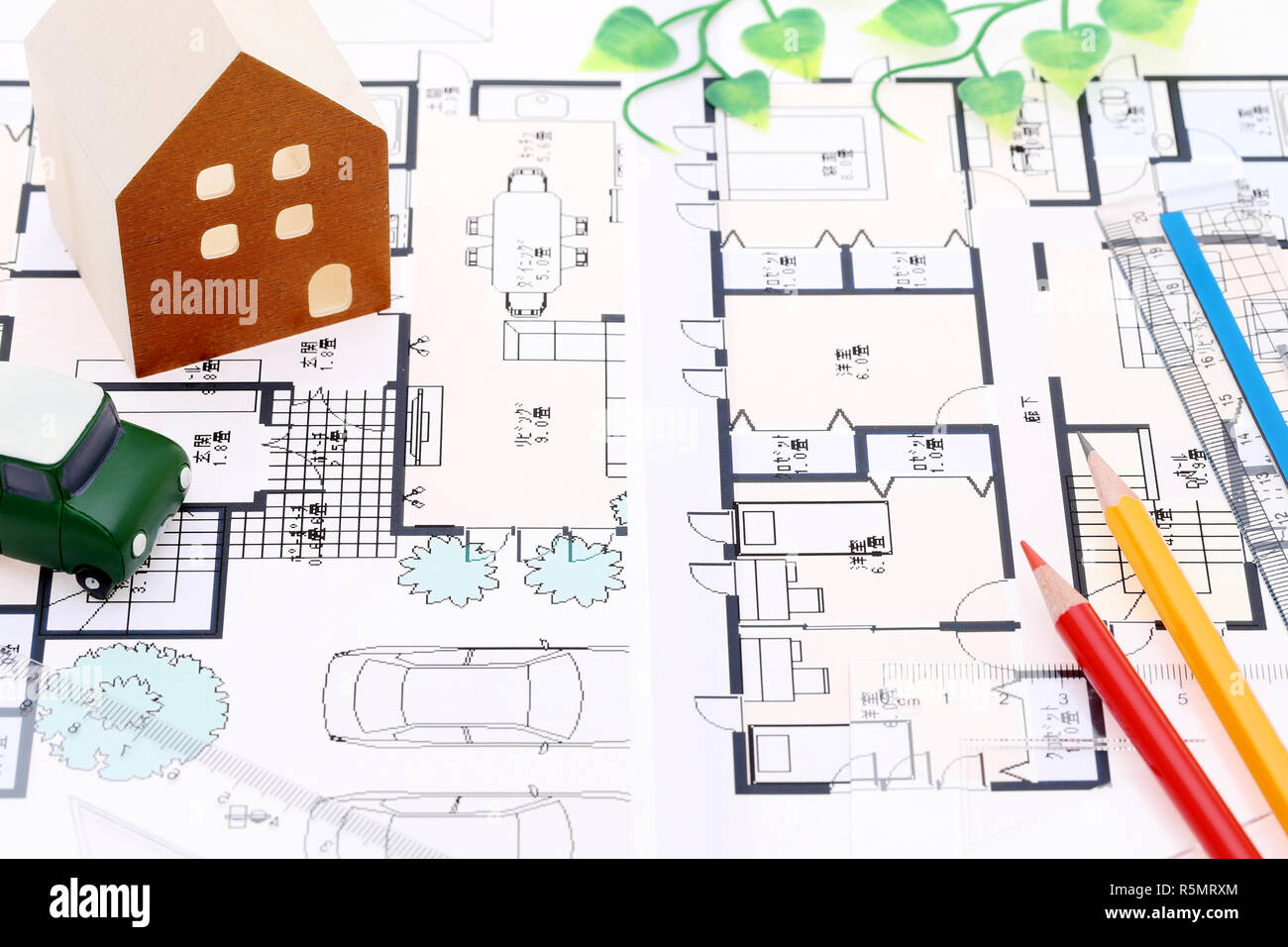 miniature model of house on blueprints, construction plan Stock Photo ...