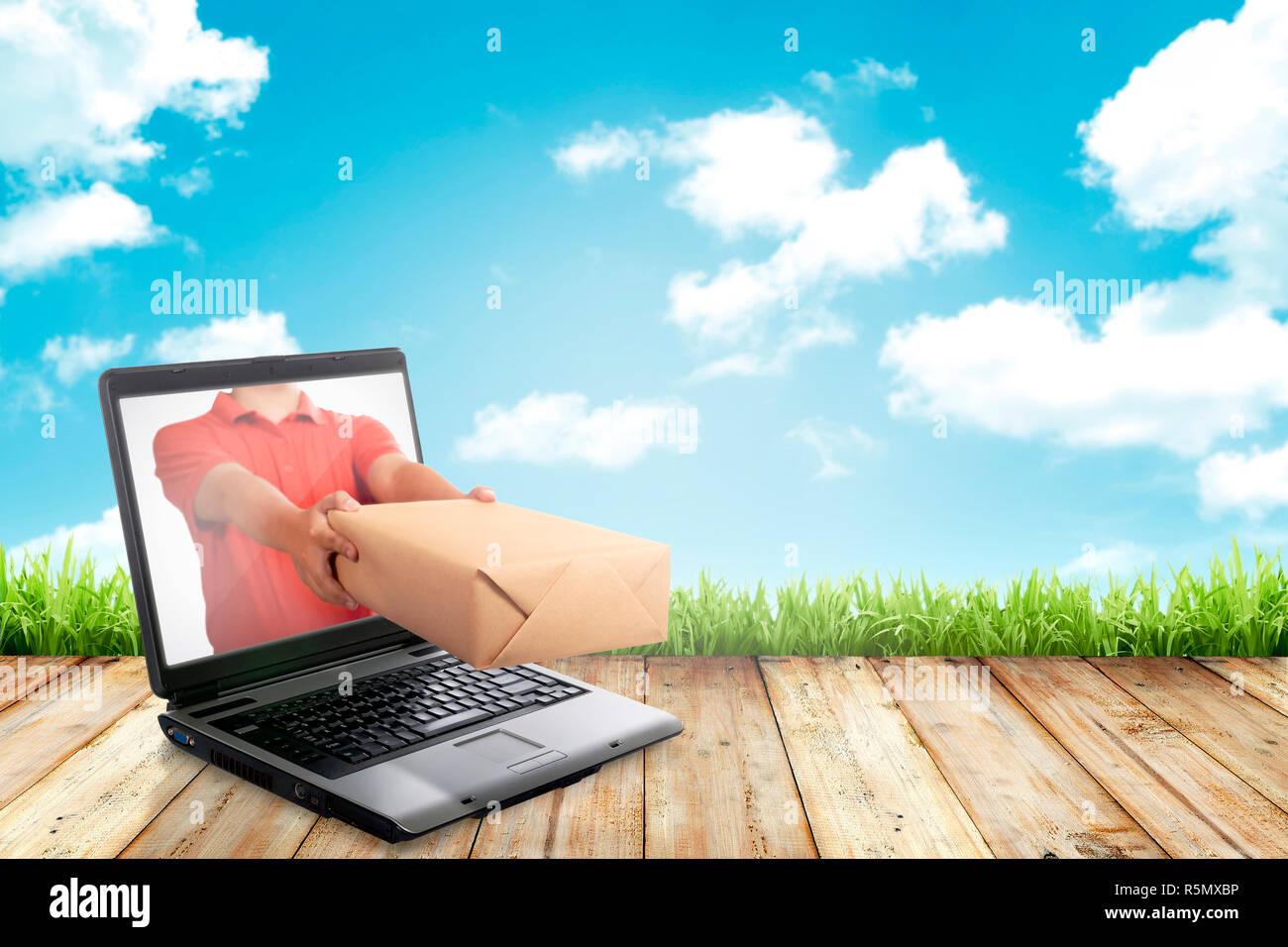 Hand giving a box out of laptop screen Stock Photo - Alamy