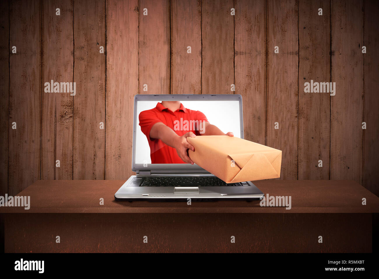 Hand giving a box out of laptop screen Stock Photo - Alamy