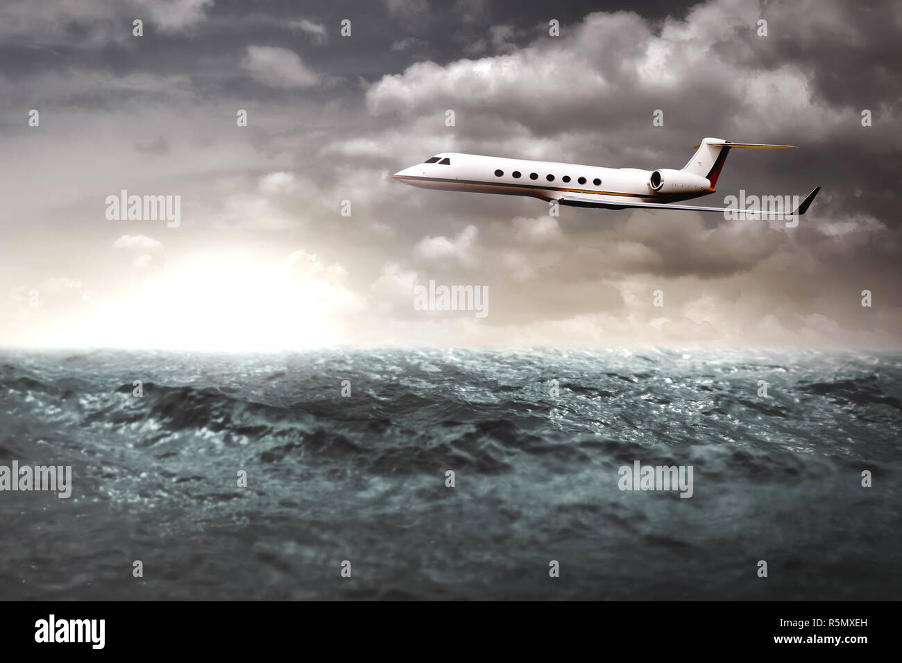 Private jet flying over the ocean Stock Photo - Alamy