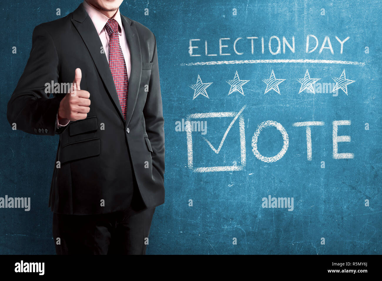 Man with business suit standing beside 'Election Day' Stock Photo - Alamy