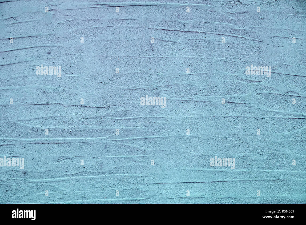 Blue wall of embossed decorative plaster Stock Photo - Alamy