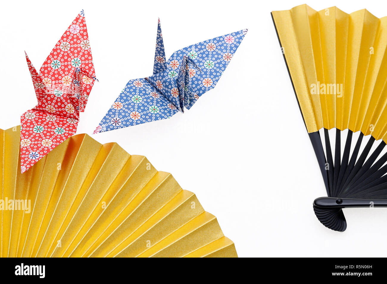golden folding fan and origami bird isolated on white background Stock ...