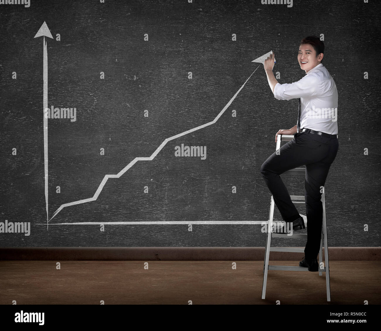 Business person drawing chart on the board Stock Photo - Alamy