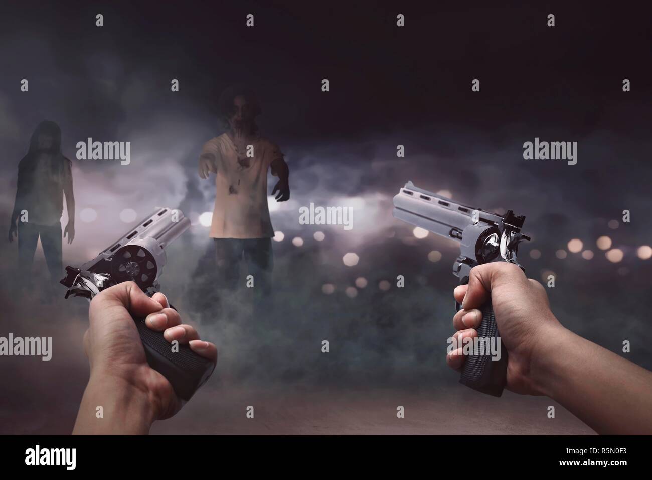 Man with two guns in his hand ready to shooting a lot creepy zombie ...