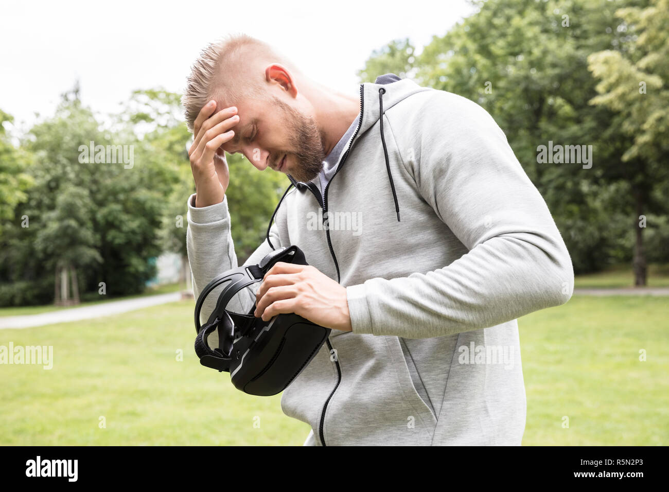 Man Feeling Tense After Long VR Simulation Stock Photo - Alamy