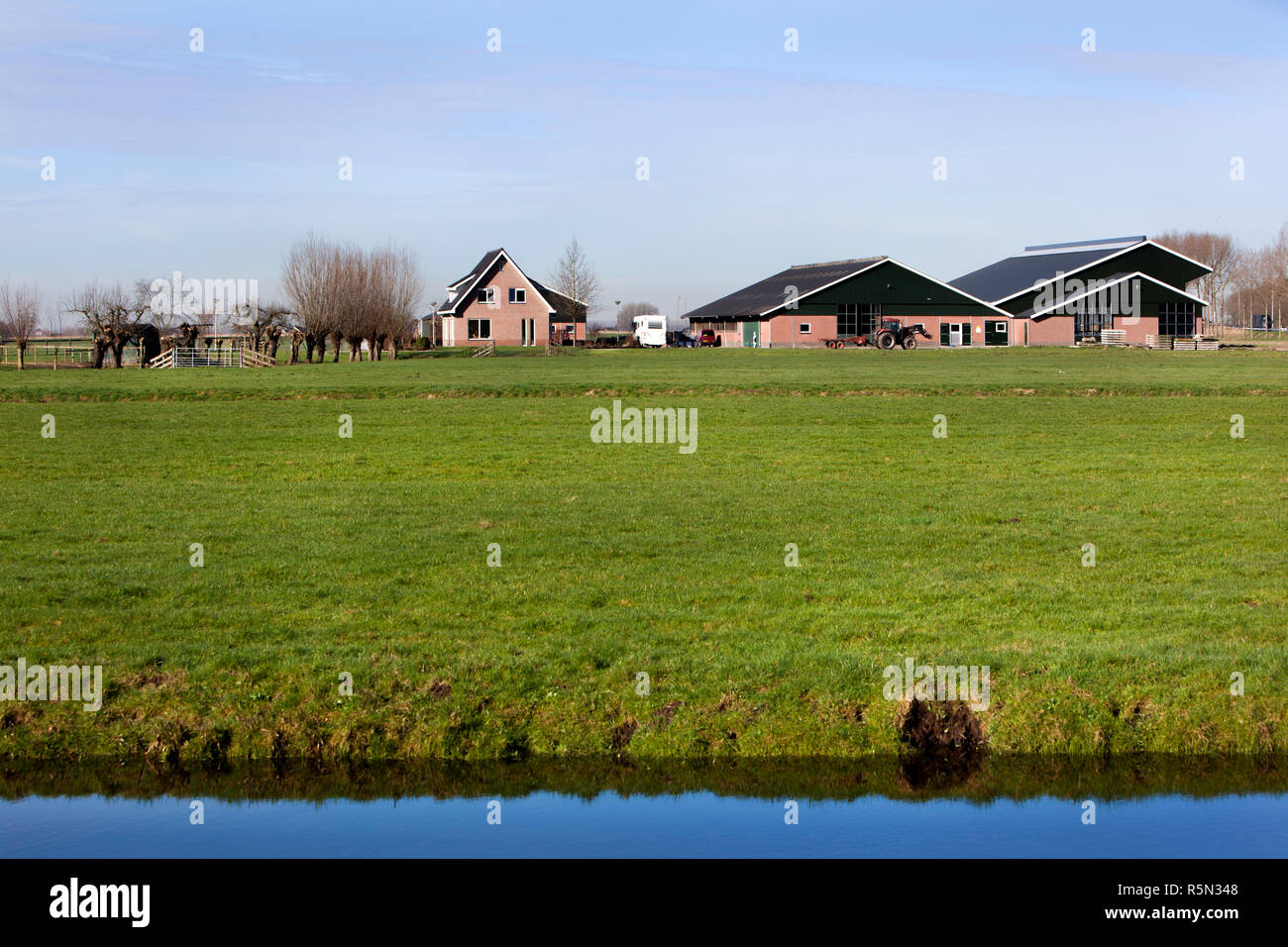 Countryside with brick house and farm Stock Photo - Alamy