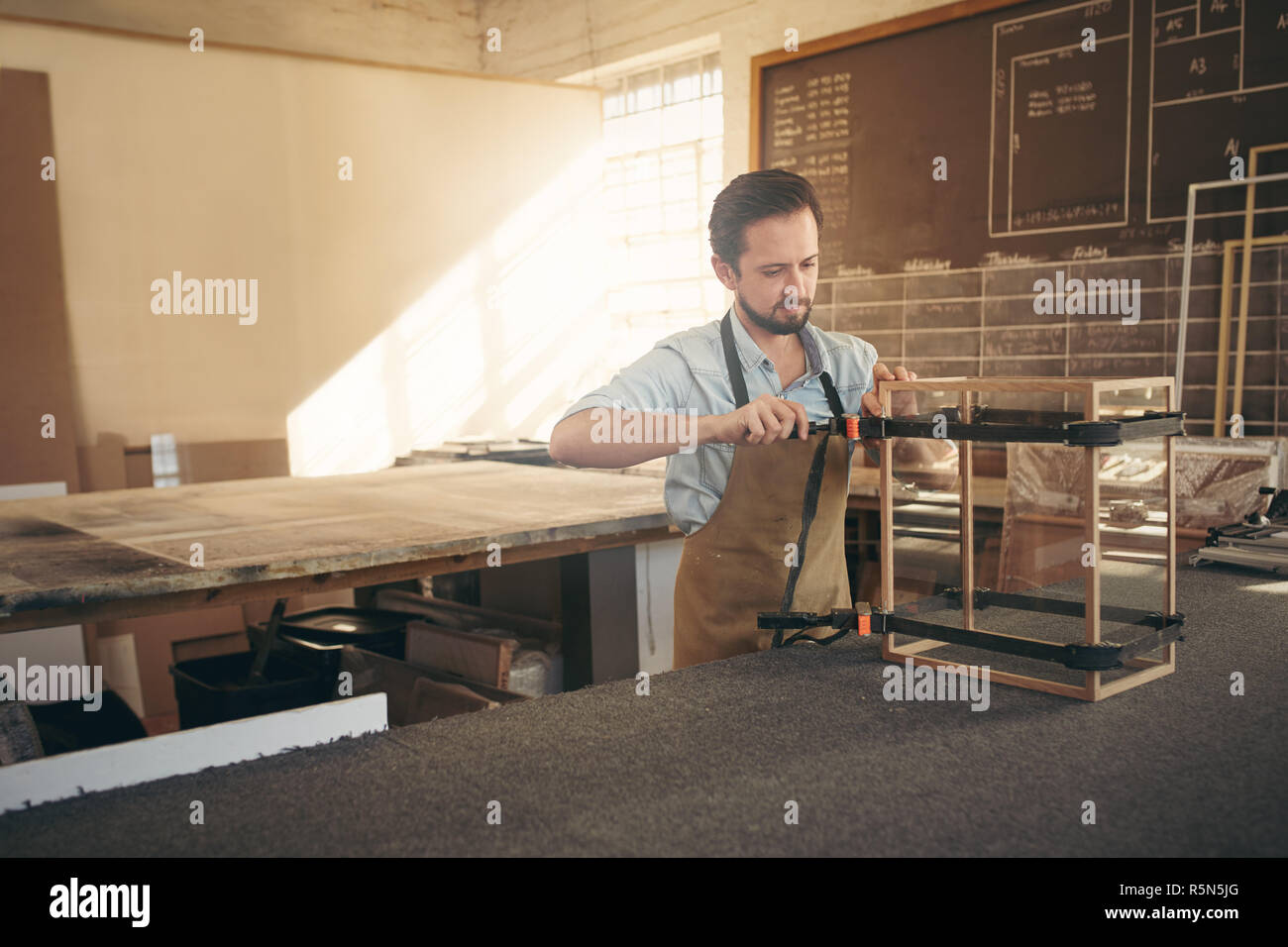 Skilled craftsman manufacturing a display case in wood worksho Stock ...