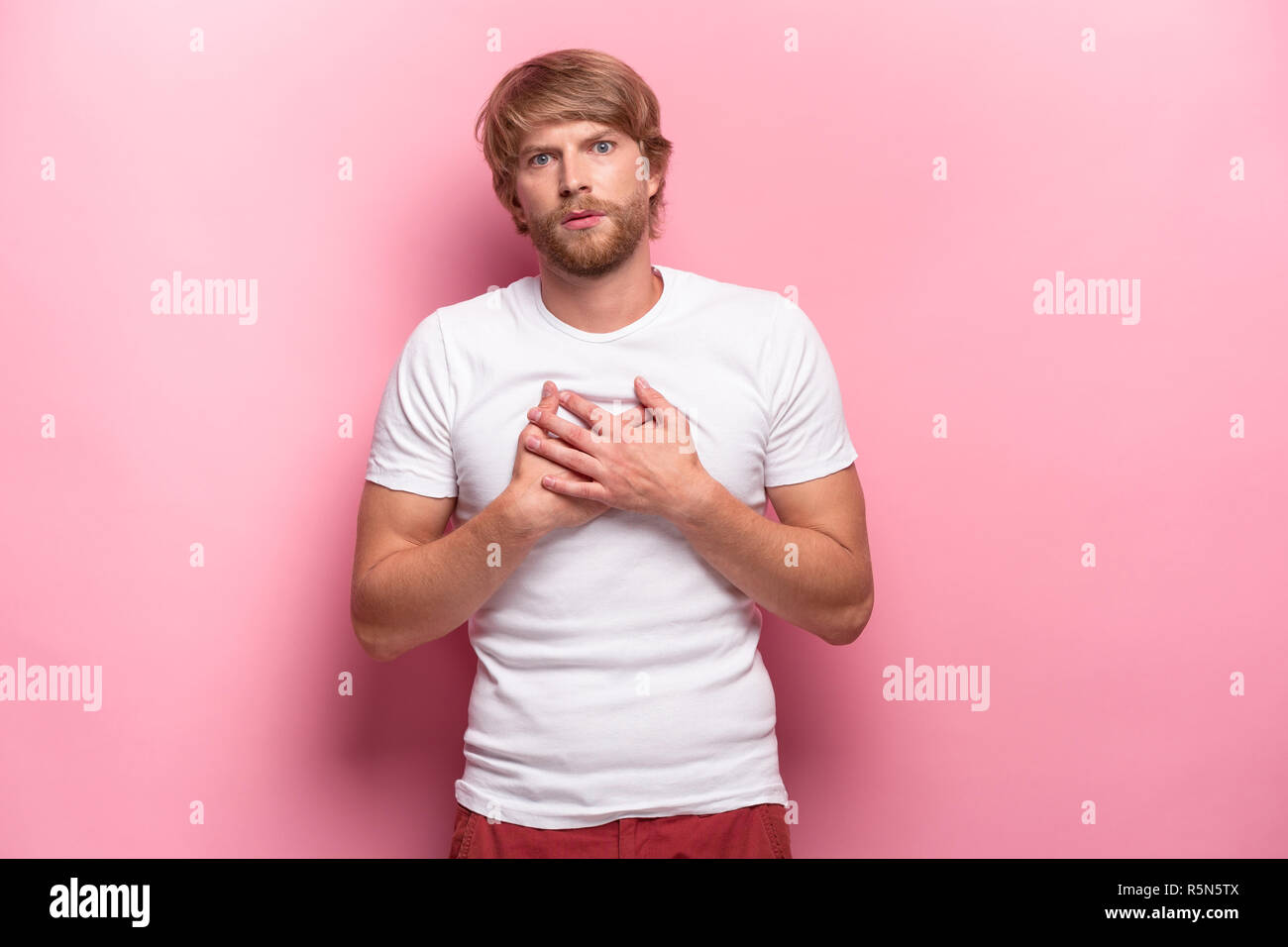 Portrait of young man with shocked facial expression Stock Photo - Alamy