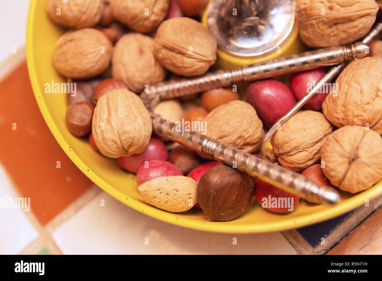 Walnuts and chestnuts in a bowl with cracking tools or utinsels Stock ...