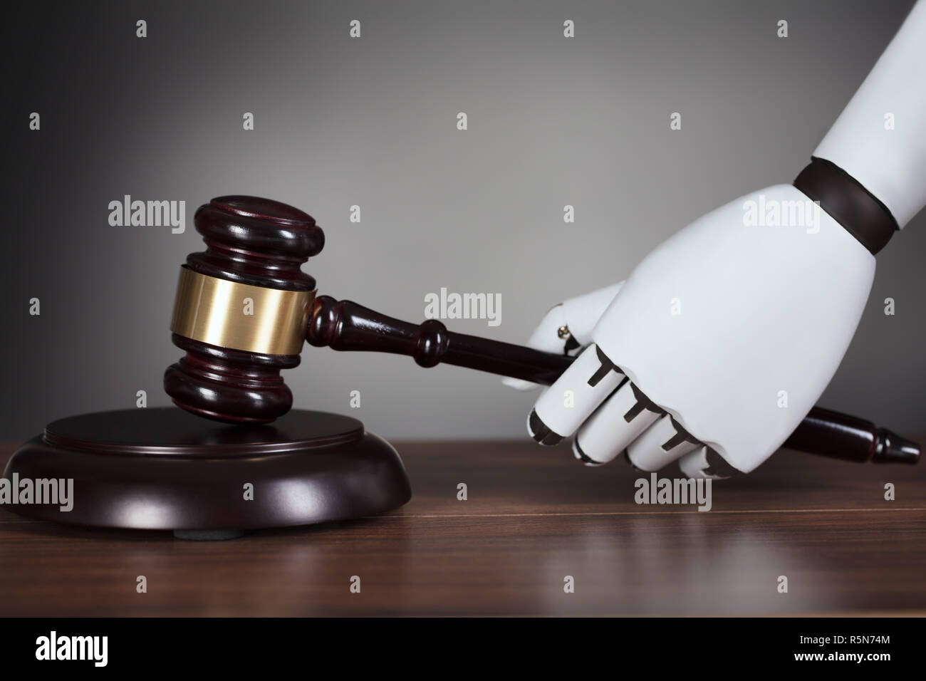 Robot's Hand Hitting Gavel At Desk Stock Photo - Alamy