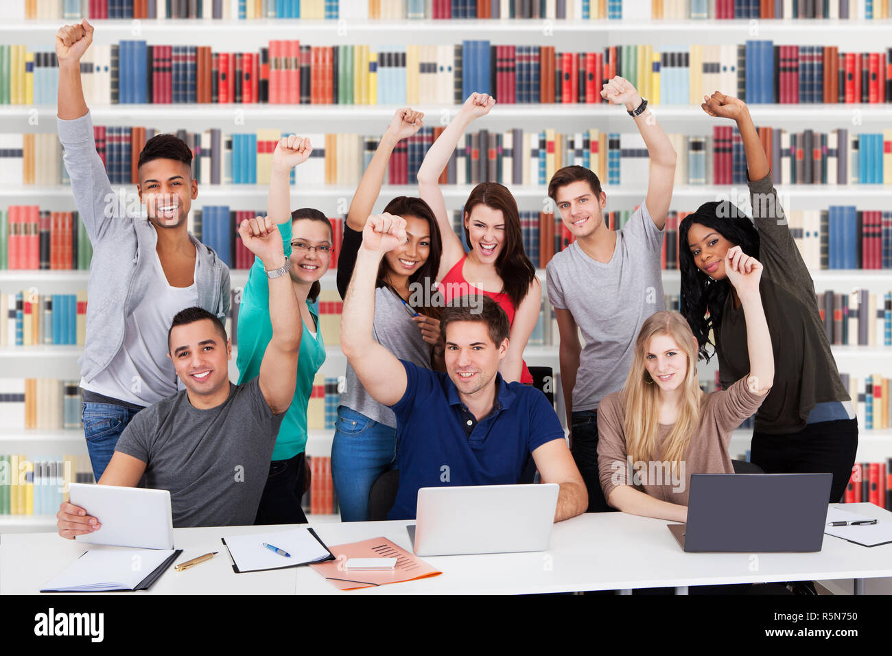 Happy College Students Celebrating Success In Classroom Stock Photo - Alamy