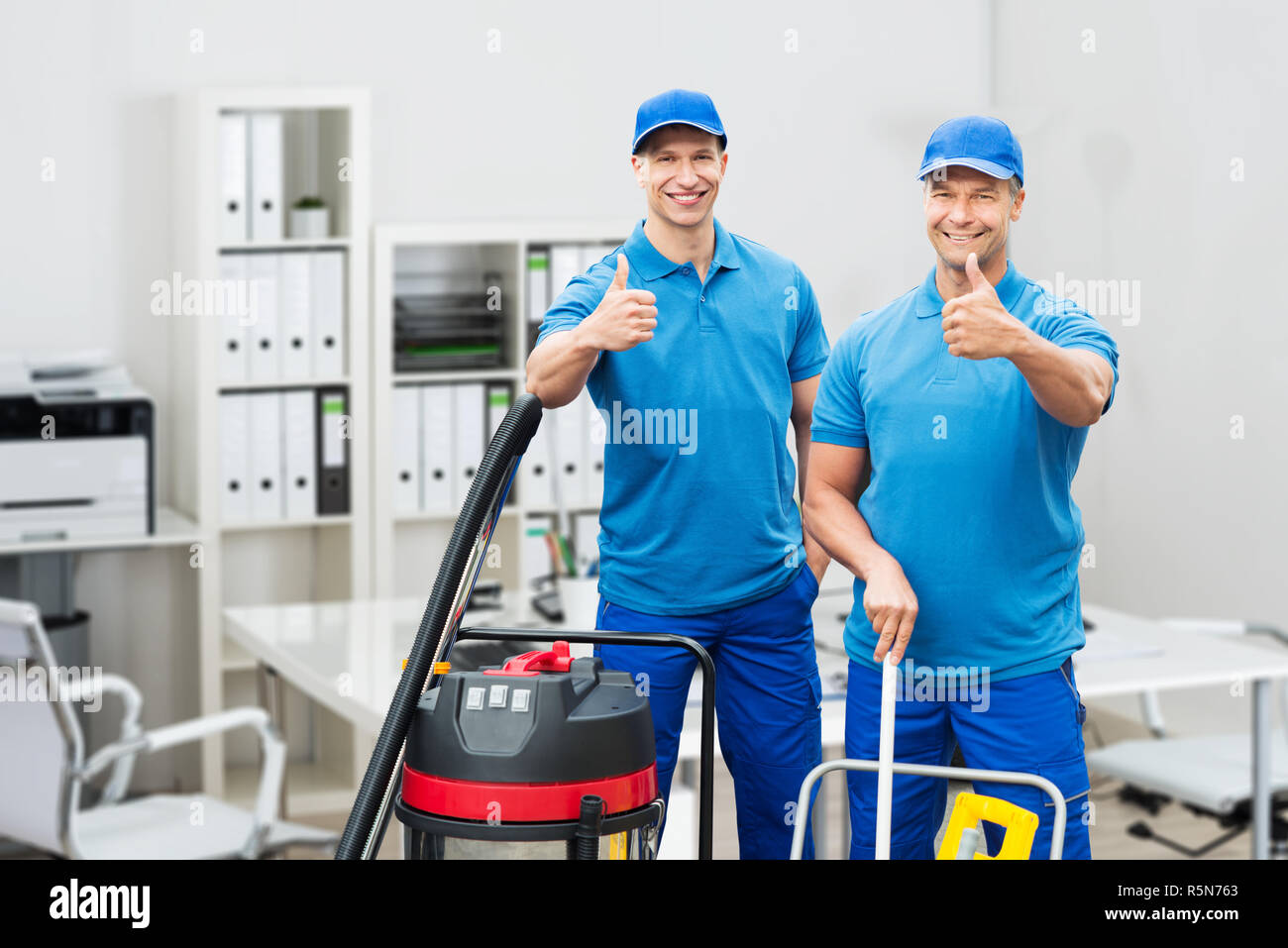 two happy Factory workers with thumb up Stock Photo - Alamy