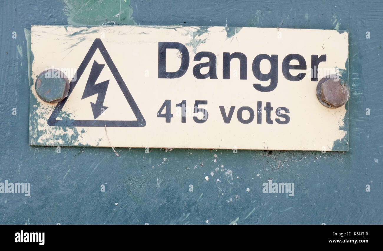 A metal sign plate on the box of electrical grid equipment station ...