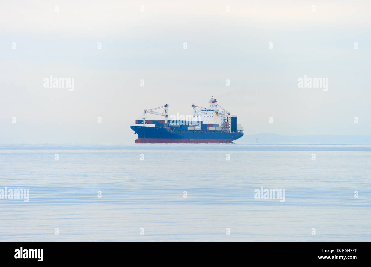 Cargo ship sailing far hi-res stock photography and images - Alamy