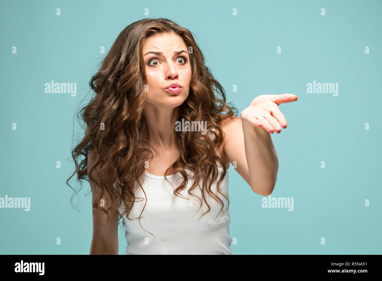 Portrait of young woman with shocked facial expression Stock Photo - Alamy