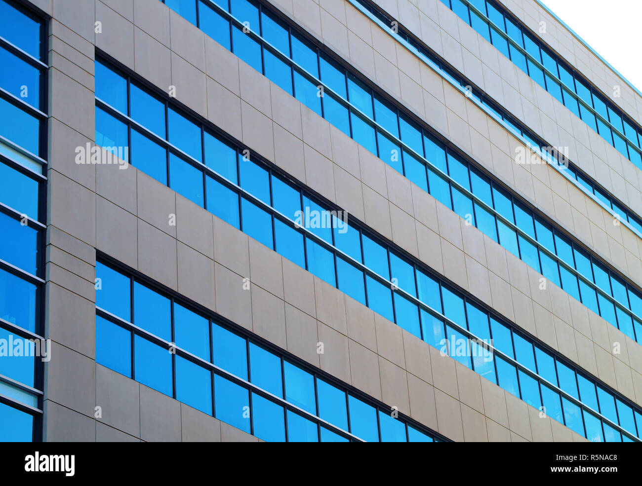 office building blue windows angle concrete Stock Photo - Alamy