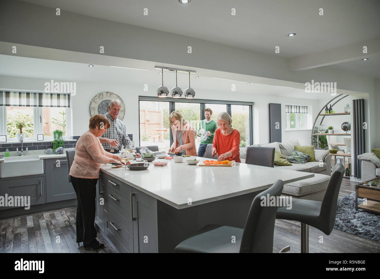Family Cooking A Meal Together Stock Photo - Alamy