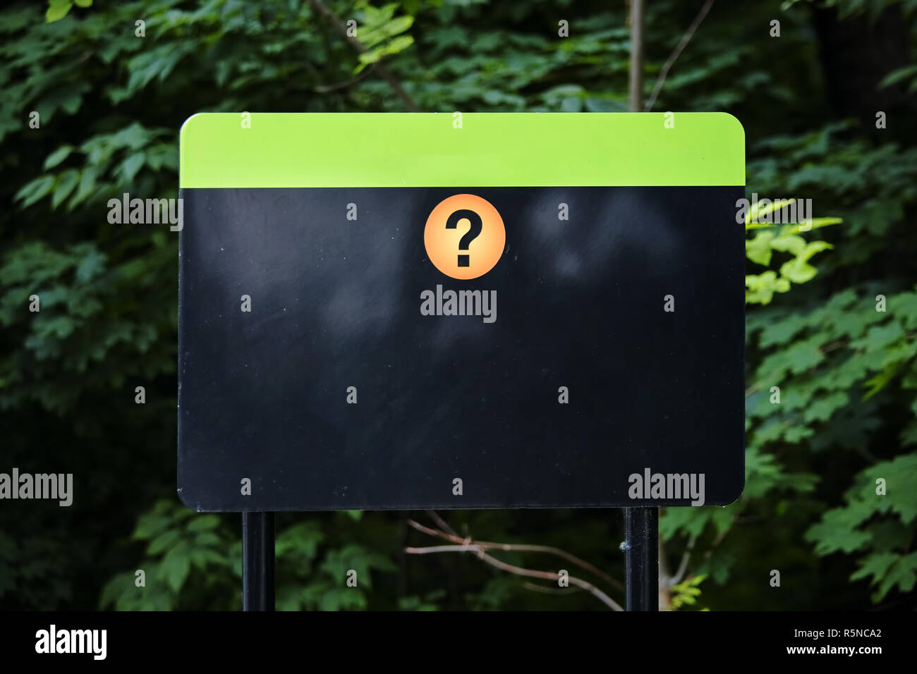 Empty black and green metal sign board with a question mark symbol in ...