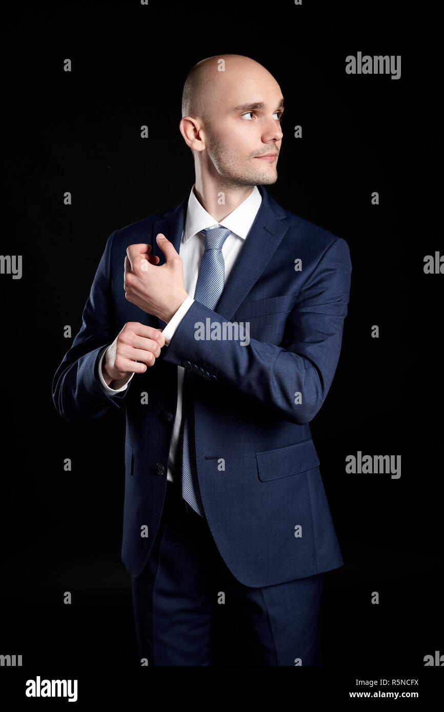 Elegant Man Fixing Cuffs his Button Down Shirt Stock Photo - Alamy