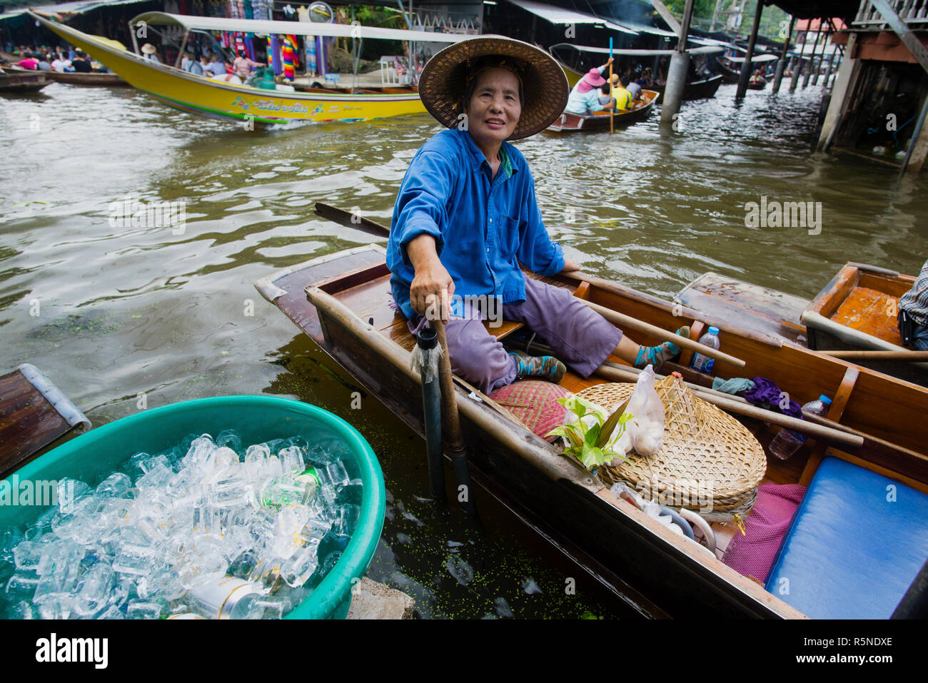 Woven hat seller at the Damnoen Saduak Floating Market on the Mae Klong ...