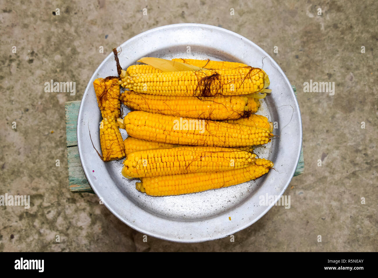 Boiled corn on an aluminum tray. Yellow boiled young corn, useful and ...