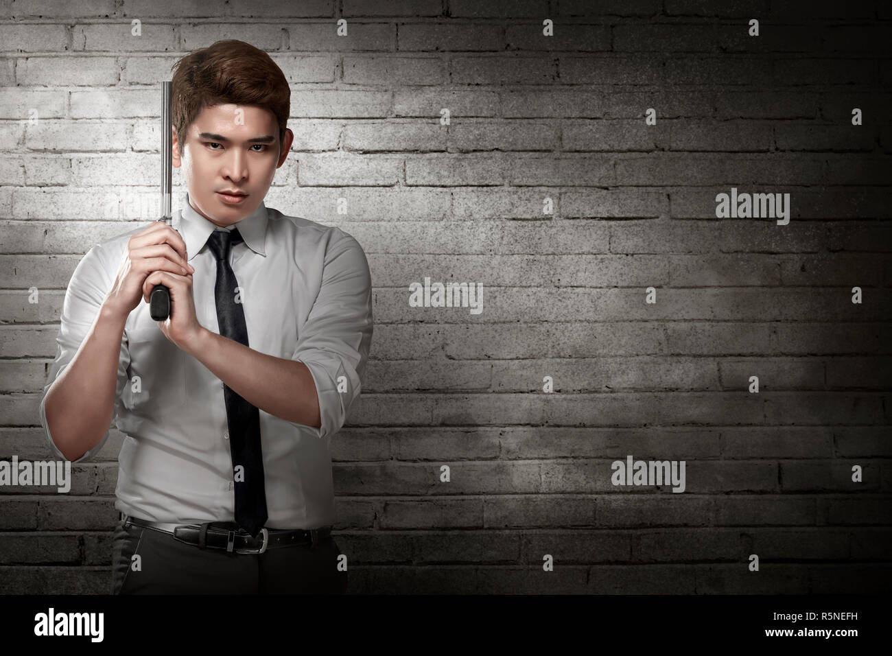 Secret Agent Holding Gun Stock Photo - Alamy