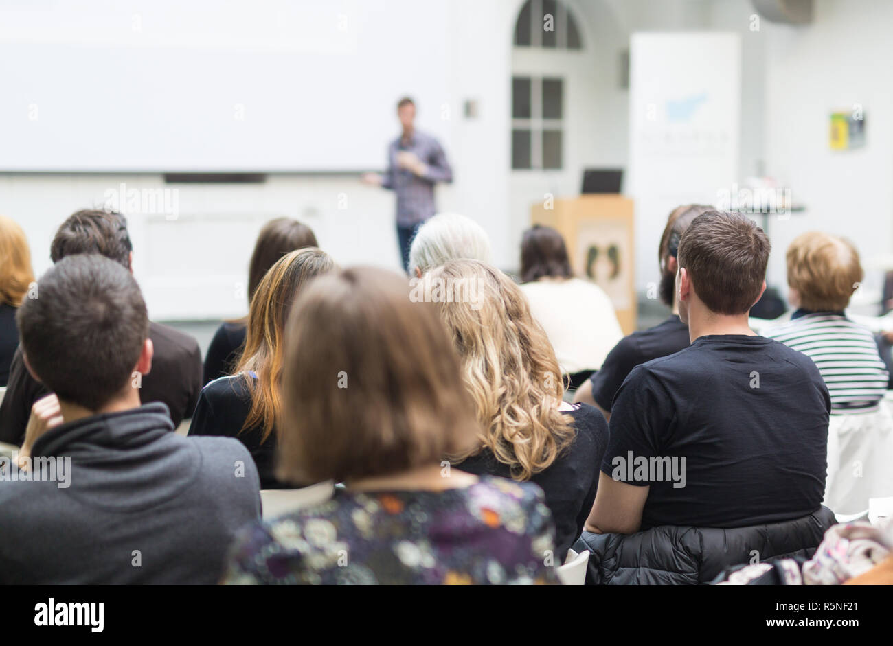 Man giving presentation in lecture hall at university Stock Photo - Alamy