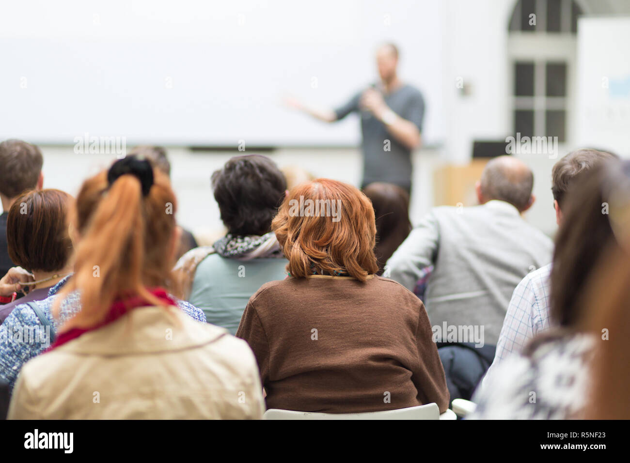 Man giving presentation in lecture hall at university Stock Photo - Alamy