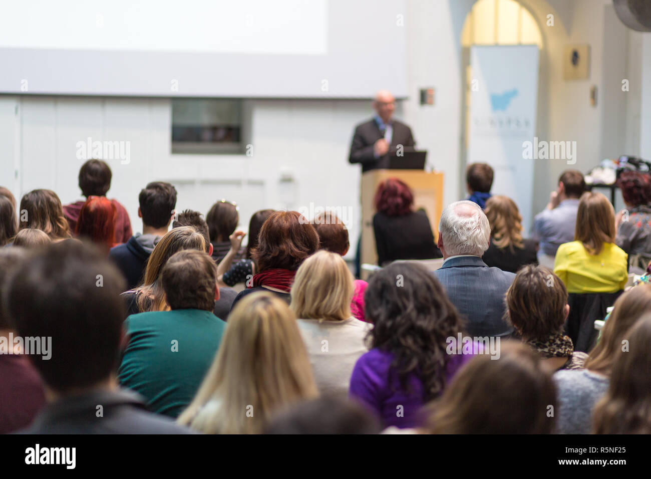 Man giving presentation in lecture hall at university Stock Photo - Alamy