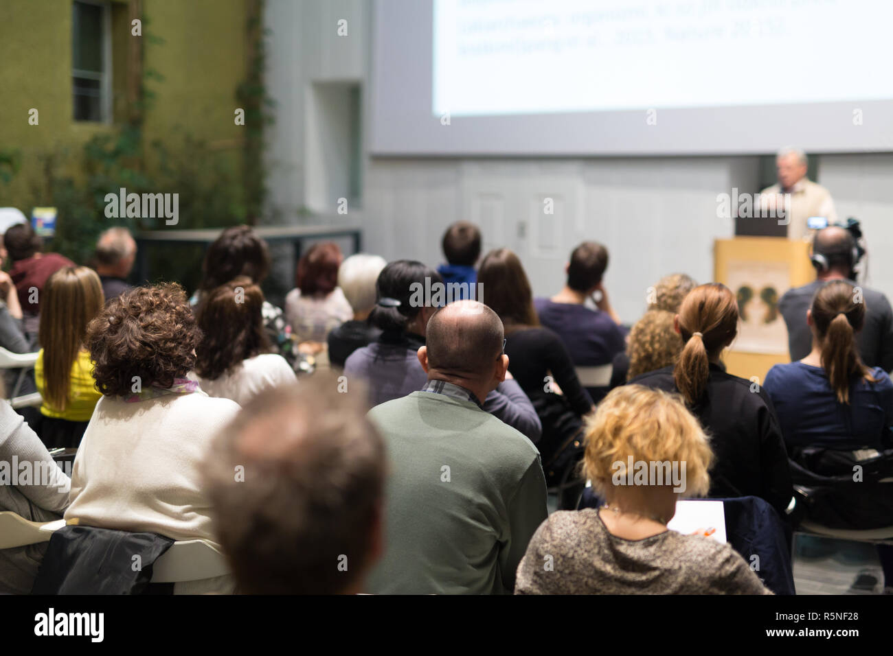 Man giving presentation in lecture hall at university Stock Photo - Alamy