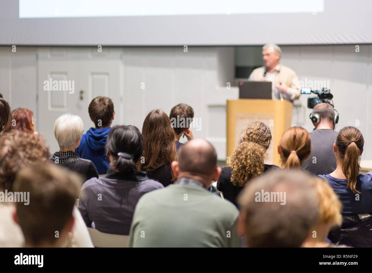 Man giving presentation in lecture hall at university Stock Photo - Alamy