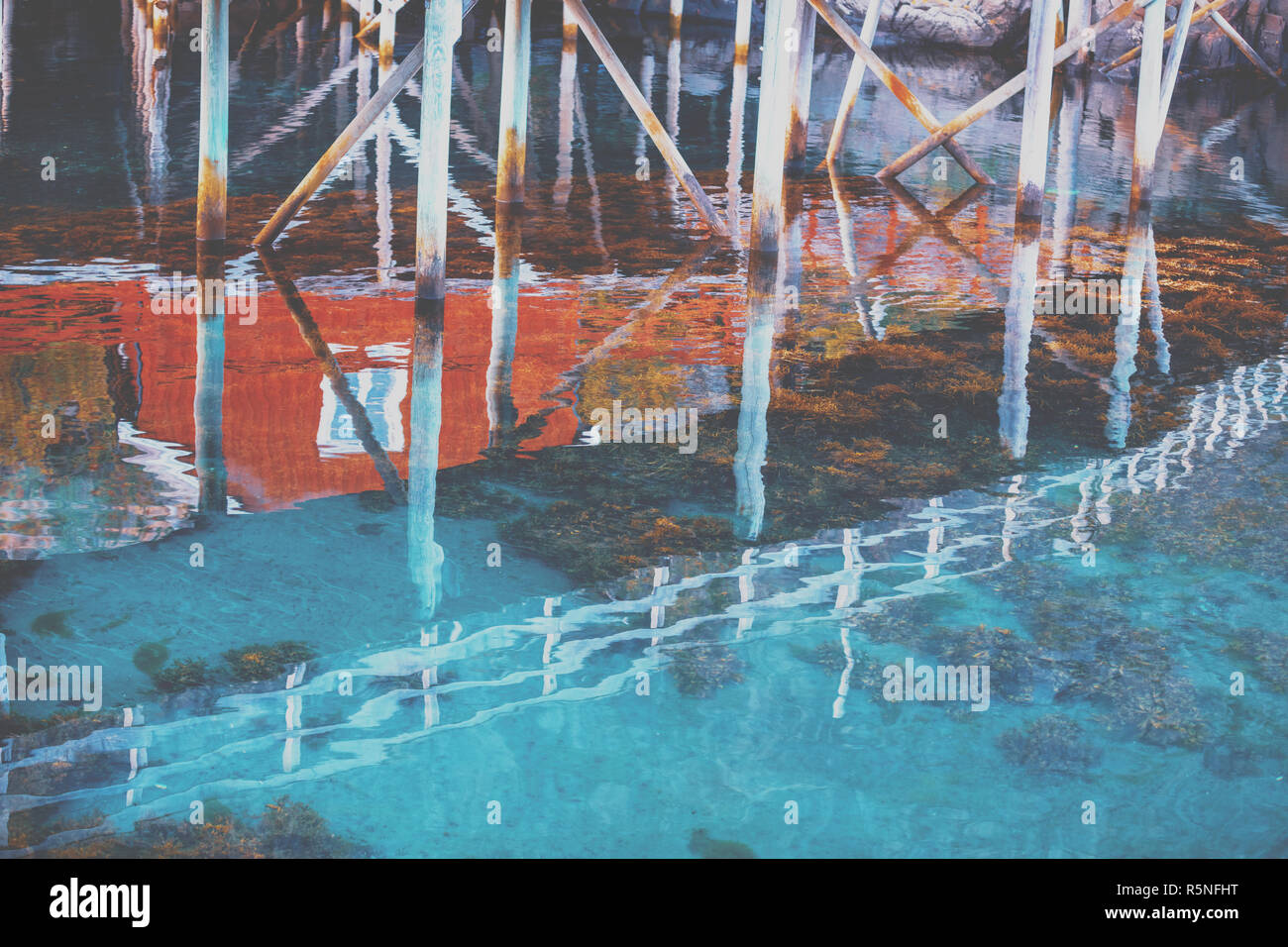 Reflection of fishing houses in the sea Stock Photo - Alamy