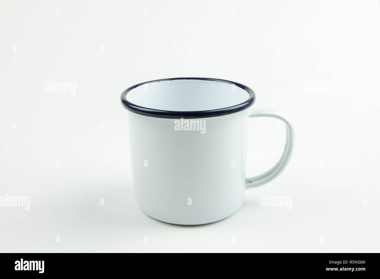 White tin cup on white background Stock Photo - Alamy
