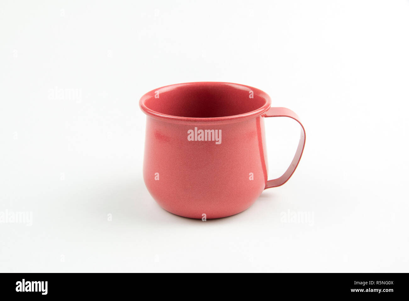 Red tin cup on white background Stock Photo - Alamy