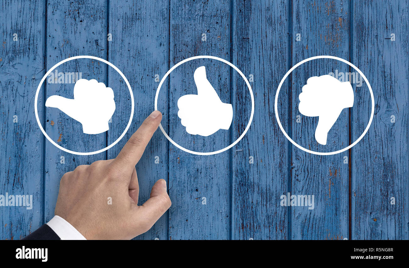 hand points to rating icons with thumbs up Stock Photo - Alamy