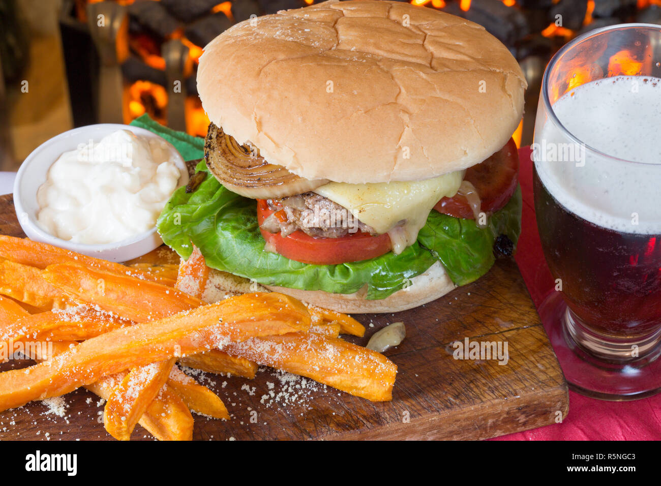 Classic English pub meal of Cheese burger with sweet potato fries and a ...