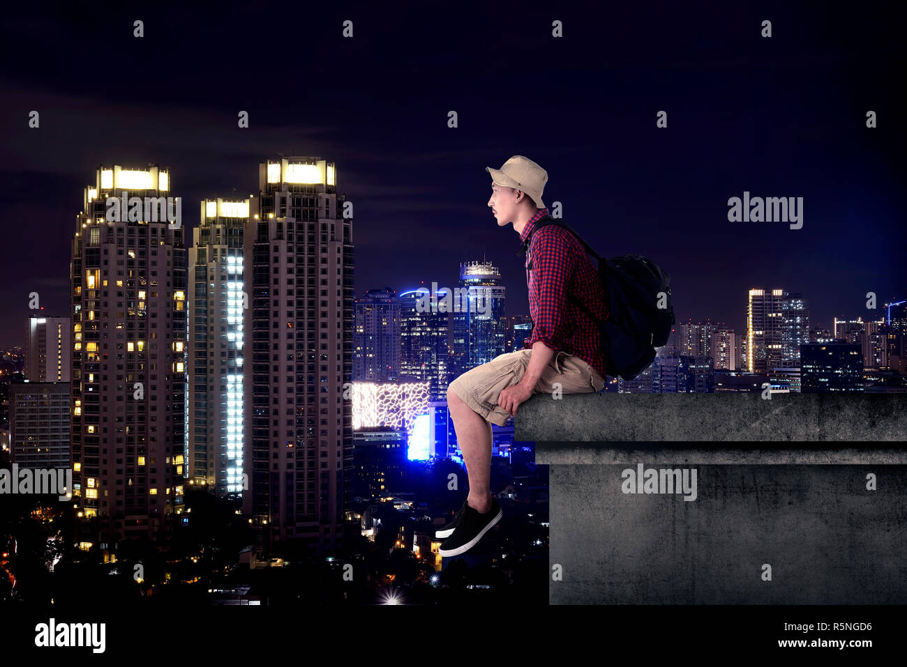 Asian tourist sitting on the building rooftop Stock Photo - Alamy
