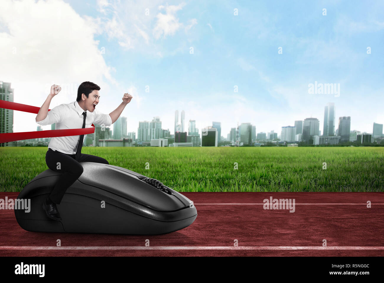 Asian business person riding computer mouse Stock Photo - Alamy