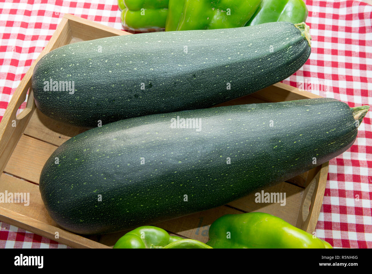 Two beautiful courgettes in wooden crate Stock Photo - Alamy