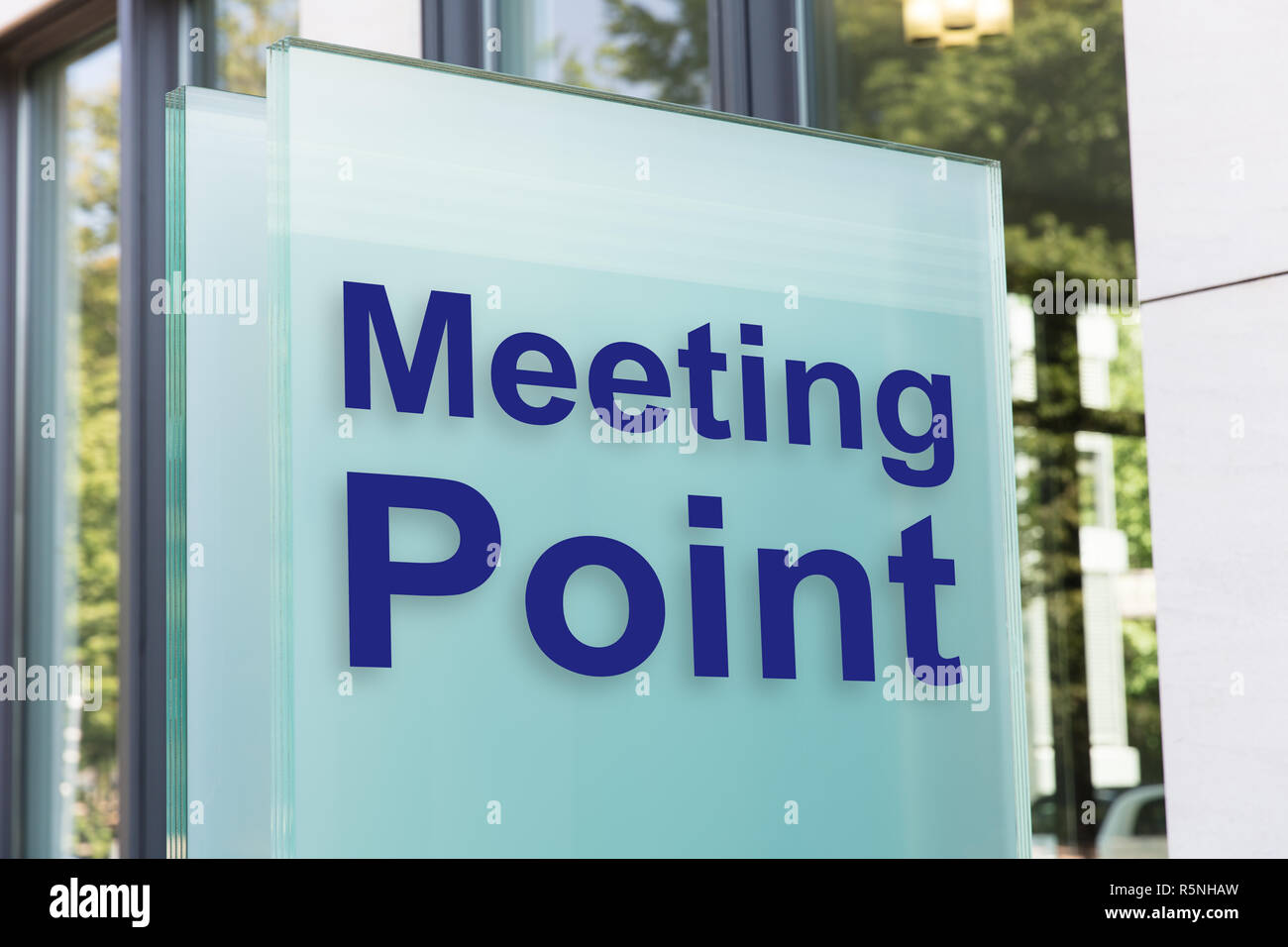 Meeting point on glass board outside building in city Stock Photo - Alamy
