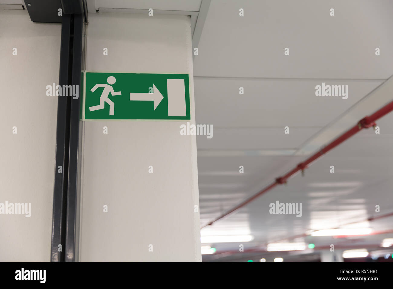 Emergency exit sign at underground parking Stock Photo - Alamy