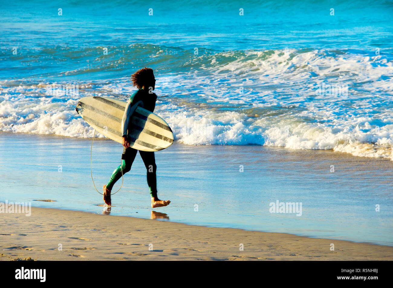 Surfer running with surfboard Stock Photo - Alamy