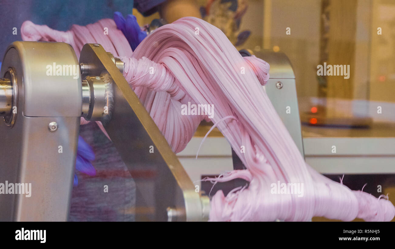 Making purple salt water taffy in small candy shop Stock Photo - Alamy