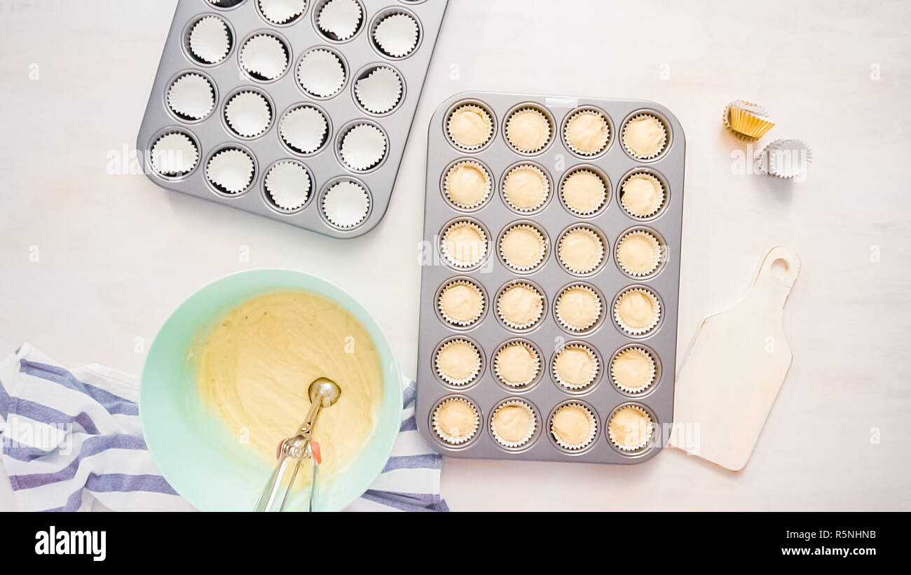 Flat lay. Scooping vanilla cupcake batter into cupcake liners Stock ...