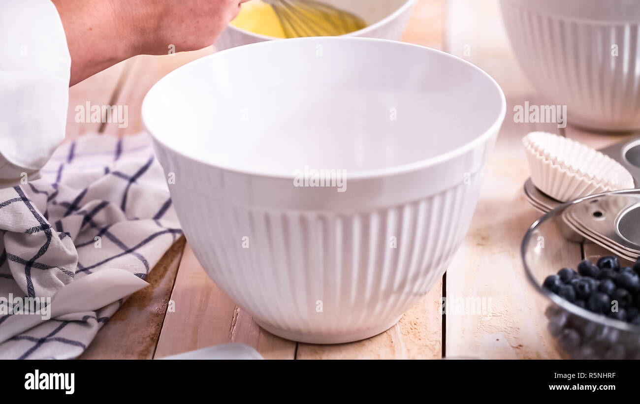 Mixing ingredients together in mixing bowl for blueberry muffins Stock ...