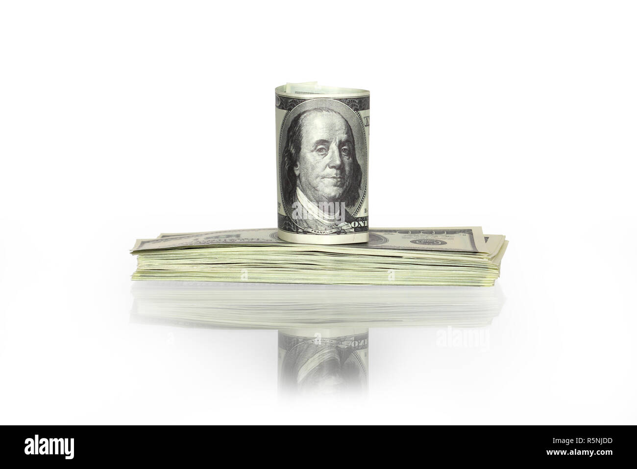 One hundred dollars note standing on stack of banknotes. Isolated with ...