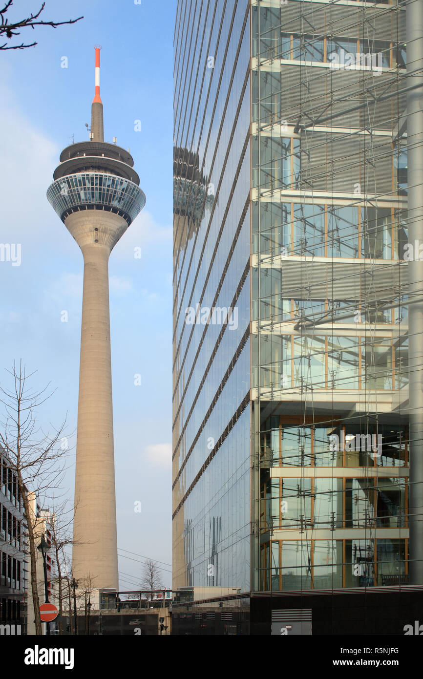 Modern glass skyscraper on background with blue sky and radio tower in ...