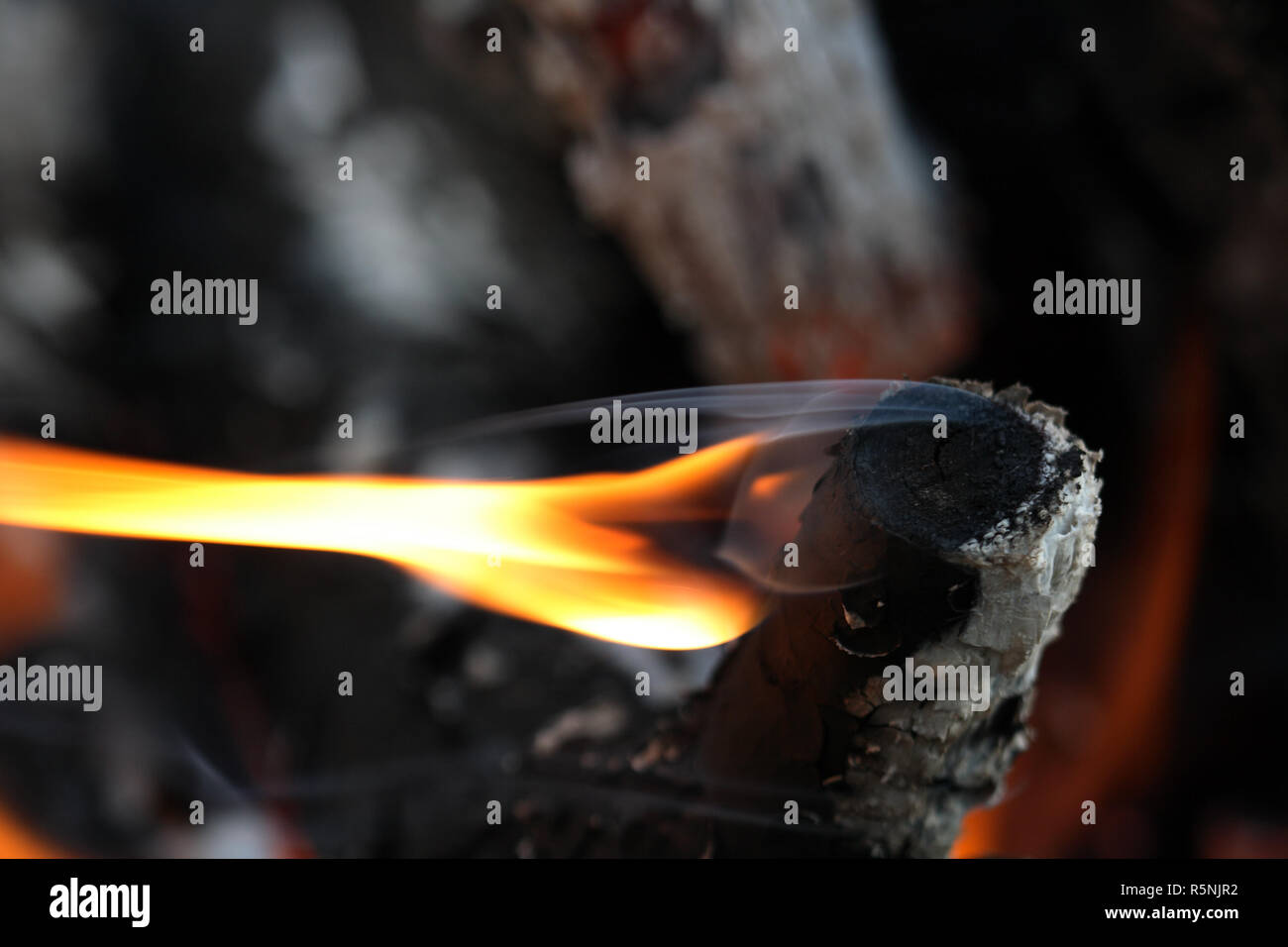 Background with single flame on dark Stock Photo - Alamy